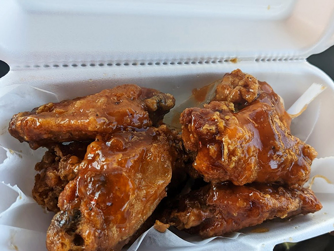 These wings aren't just sauced, they're baptized &ndash; glistening with a sticky glaze that promises to redecorate your shirt and your taste buds.