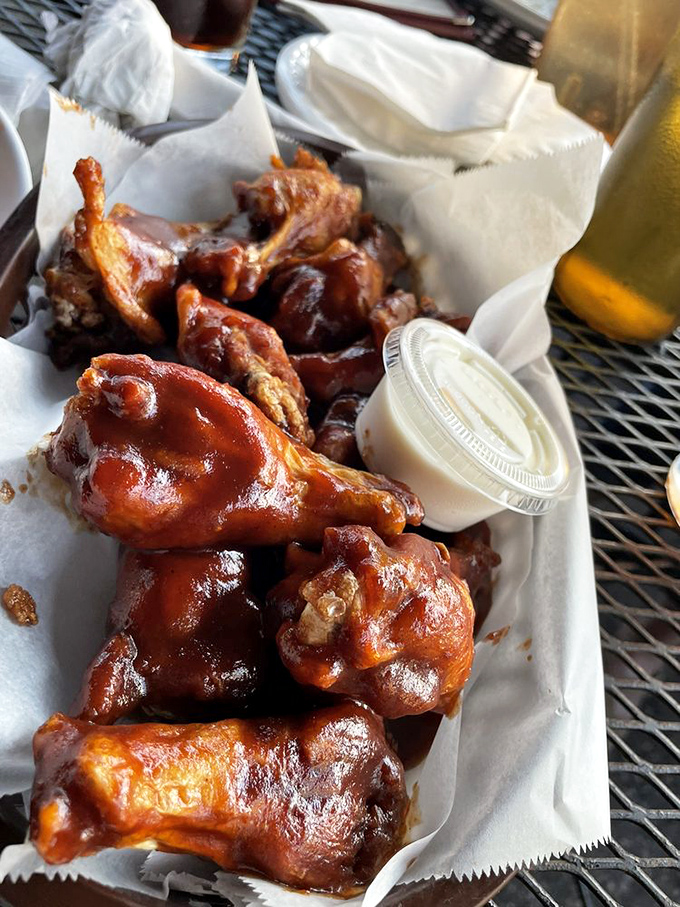 These wings aren't just glazed; they're lacquered with sticky, sweet-heat sauce that'll have you licking your fingers shamelessly. Napkins required, restraint optional.