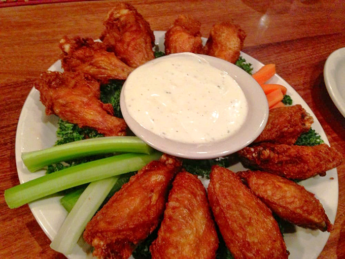 These wings aren't just appetizers; they're a masterclass in crispiness, arranged like a sunburst around a creamy dipping sauce sanctuary.