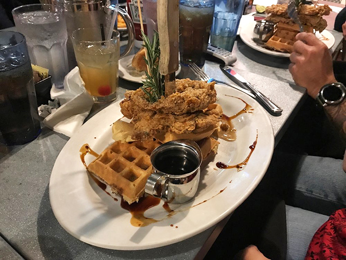 Chicken and waffles engaged in a delicious skyscraper competition, with maple syrup acting as delicious mortar between sweet and savory floors.
