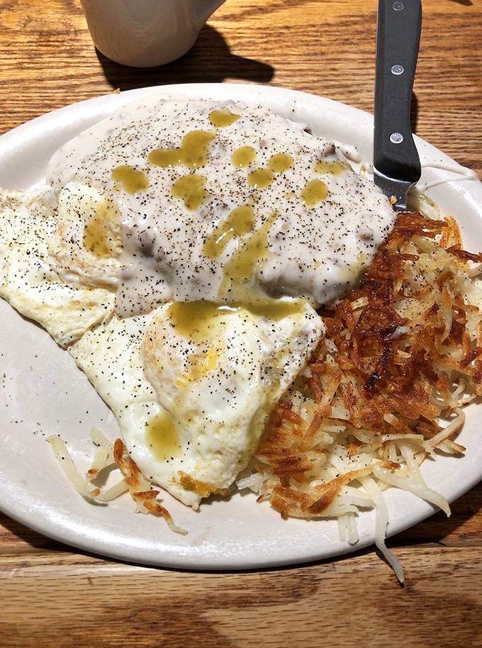 Eggs with a side of crispy hash browns and a drizzle of country gravy—the breakfast equivalent of a warm hug from someone who actually likes you.