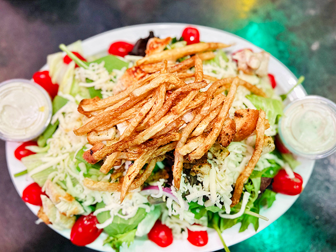 Even the salads mean business here. Fresh greens topped with crispy fries&mdash;because vegetables should have fun too.