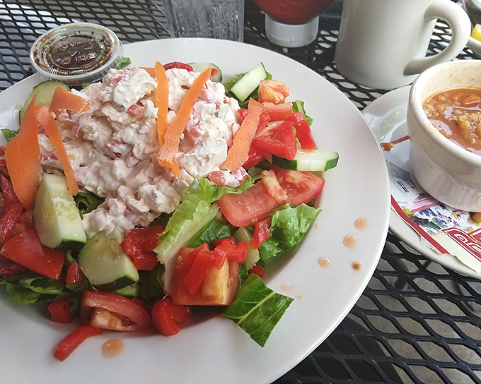 When a chicken salad comes with this many fresh vegetables, you can tell yourself it's health food. The self-deception is part of the experience.