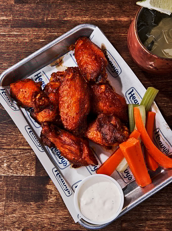 These wings aren't just tossed in sauce&mdash;they're baptized in it. Served with veggies that pretend you're making healthy choices.