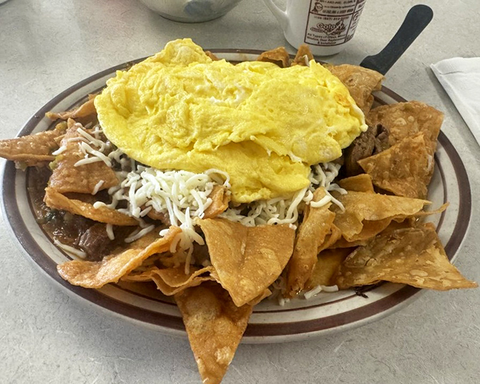 These chilaquiles aren't just breakfast—they're a fiesta on a plate. Crispy tortilla chips swimming in sauce, crowned with eggs that make ordinary mornings extraordinary.