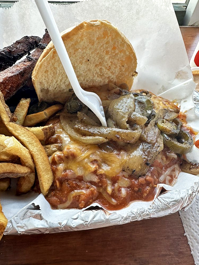 When chili, cheese, and onions join forces with a burger, it's not just a meal—it's a delicious conspiracy against your dry cleaning bill.