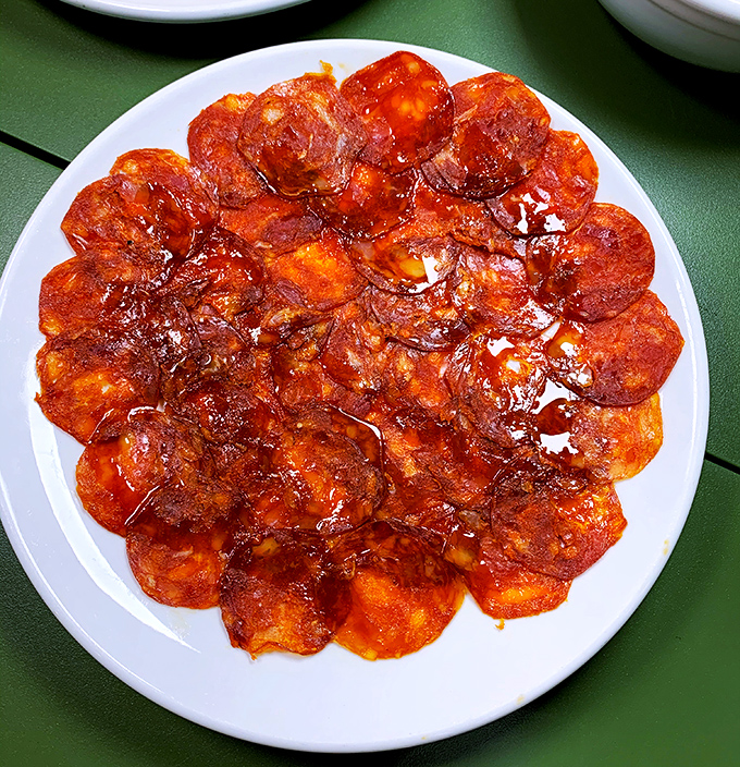 Chorizo sliced so thin you could read the newspaper through it. A plate of pure flavor that demands to be savored slowly.