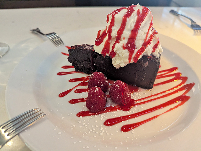 A chocolate brownies that doesn't just satisfy your sweet tooth—it throws a party for it, complete with raspberry confetti and whipped cream.