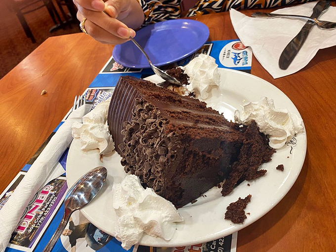 A chocolate cake so decadent it should come with a warning label. That whipped cream perimeter isn't decoration&mdash;it's crowd control.