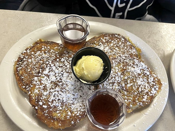 French toast that's been powdered, buttered, and syruped into breakfast royalty. The kind that makes you forget about your diet until tomorrow.