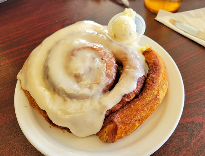 The cinnamon roll that launched a thousand return visits, with icing so perfectly melted it should have its own Instagram account.
