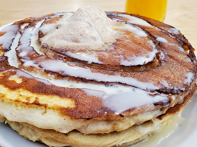 Cinnamon roll pancakes crowned with icing &ndash; proof that breakfast dessert isn't an oxymoron, it's a life philosophy.