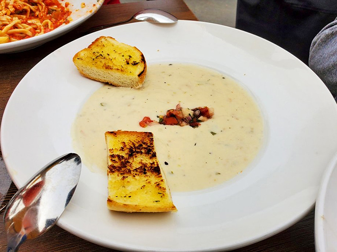 Fishwife's clam chowder arrives with garlic bread soldiers, ready to soak up every creamy, potato-laden spoonful of coastal comfort.