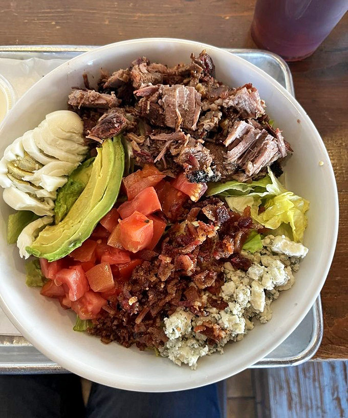 Even salads get the royal treatment here, crowned with brisket that transforms greens into pure indulgence.