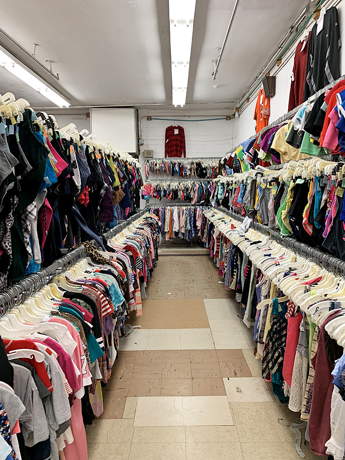 The clothing corridor feels endless, a textile time machine where decades of fashion trends coexist in democratic harmony.