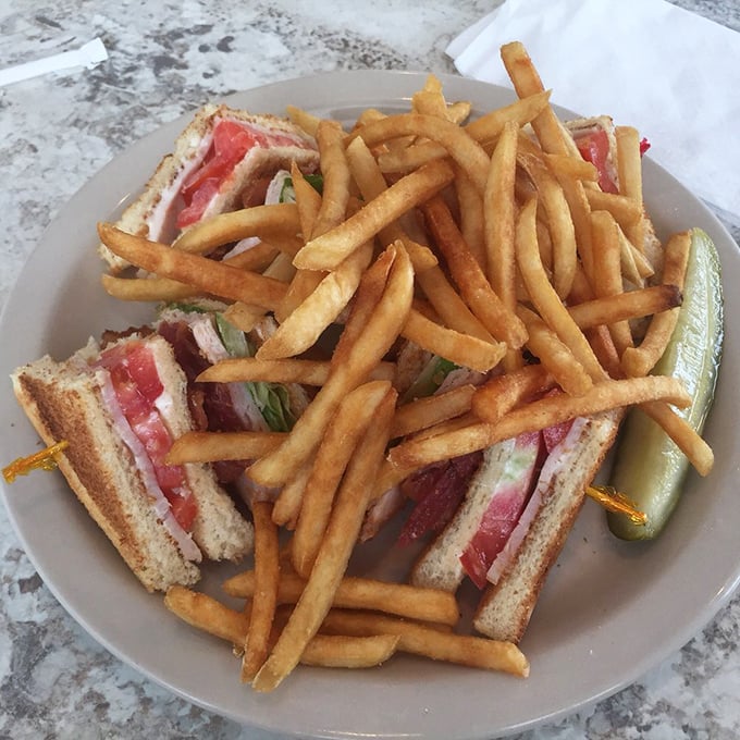 The club sandwich: architectural marvel of the lunch world, with perfectly golden fries standing at attention alongside.