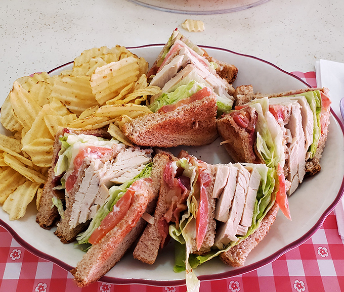 The club sandwich&mdash;an architectural marvel of turkey, bacon, and structural integrity that makes modern small plates look like a practical joke.