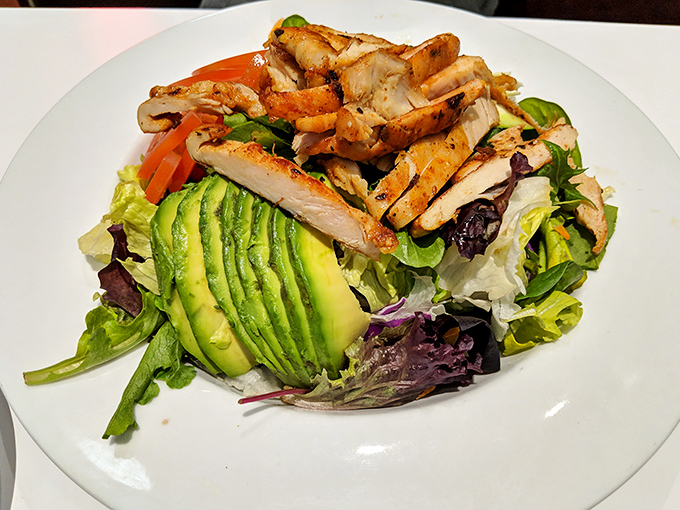 When a salad looks this good, even dedicated carnivores pause. Perfectly fanned avocado and grilled chicken make this the Cadillac of healthy options.