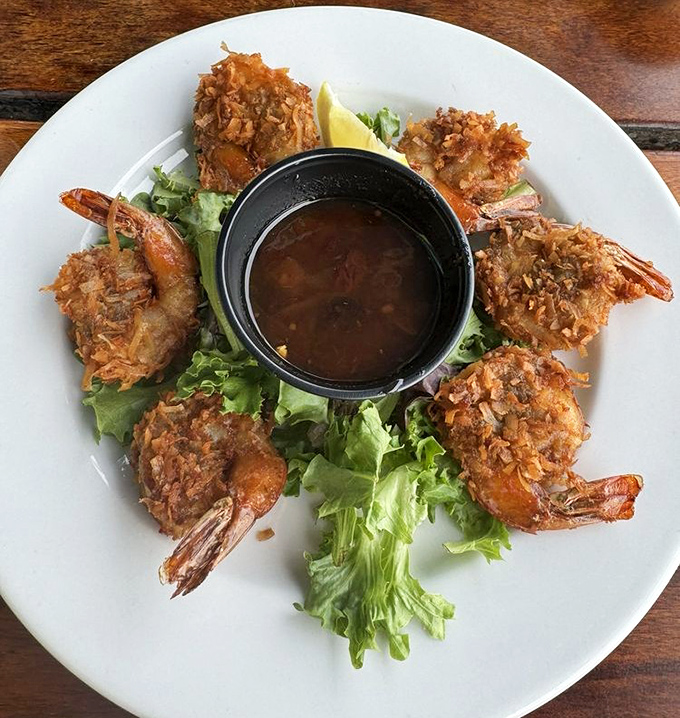 Coconut shrimp that crunch louder than your dad in the pantry at midnight. Perfectly golden, served with a dipping sauce worth bottling and taking home.