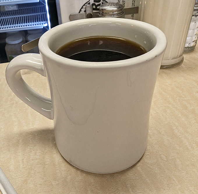 That sturdy white mug isn't just holding coffee&mdash;it's holding possibility. The first sip is like hitting the reset button on your day.