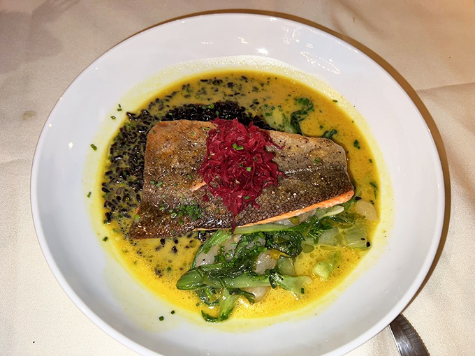 Salmon that's dressed better than most people at the Oscars, with a vibrant red topping that adds both color and flavor.