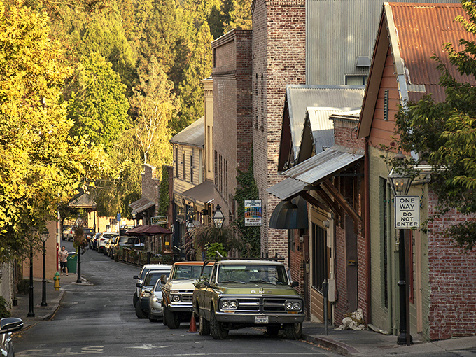 Commercial Street's gentle curve reveals architectural treasures at every glance, with vintage trucks adding authenticity no production designer could fake.