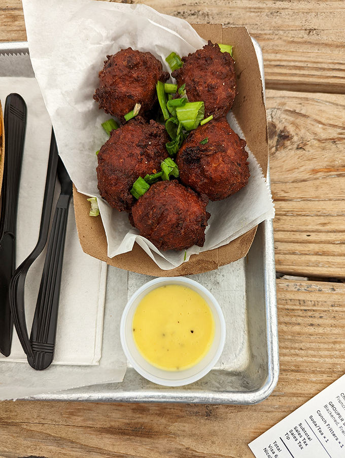 Conch fritters that could make a Bahamian weep with joy &ndash; crispy outside, tender inside, and served with a sauce that deserves its own fan club.