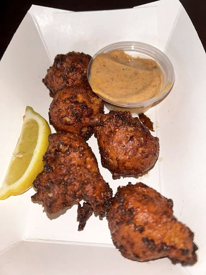 Conch fritters golden as buried treasure, served with a dipping sauce that should be bottled and sold as "Happiness in Condiment Form."
