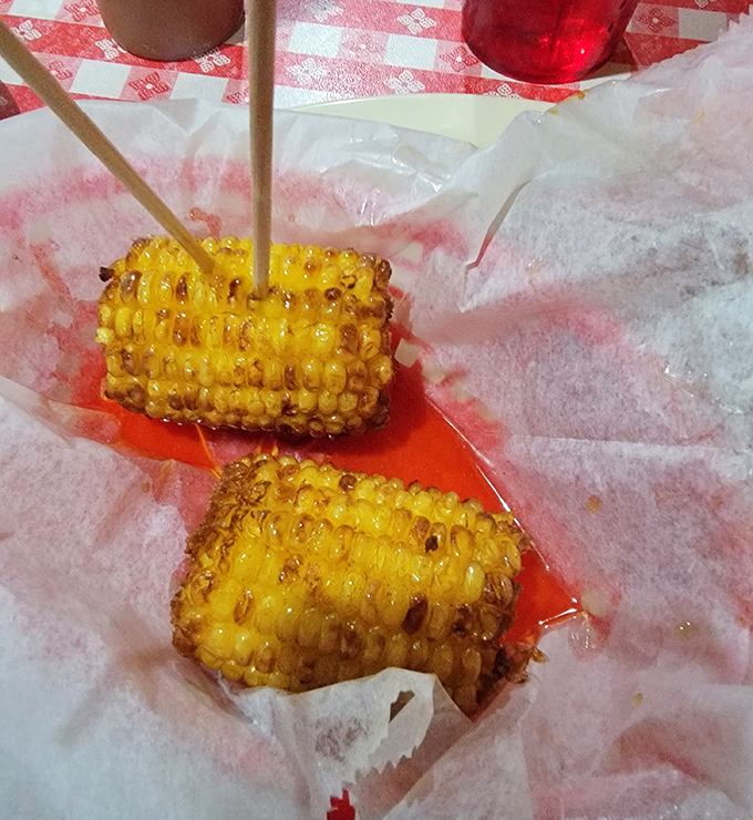 Corn on the cob that's been kissed by fire and skewered for your convenience. Summer on a stick, no matter what month it is.