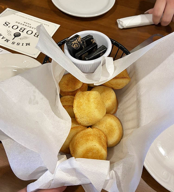 These aren't just cornbread muffins; they're warm, golden tickets to Southern heaven, served with the kind of butter that makes everything better.