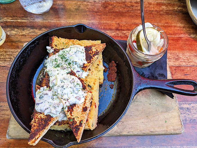 This cornbread stack towers like edible architecture, defying gravity and common sense in delicious ways.