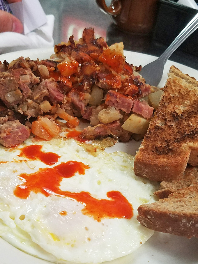 Corned beef hash with eggs and toast - the holy trinity of hearty breakfast satisfaction done absolutely right.