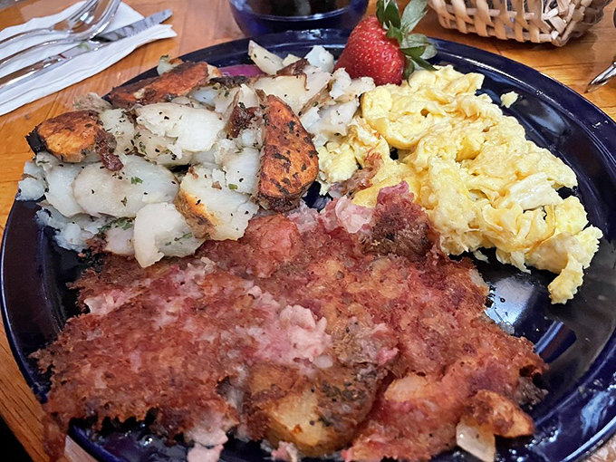 The breakfast trifecta: crispy potatoes, fluffy scrambled eggs, and corned beef hash with the perfect crisp-to-tender ratio. Morning glory on a plate.