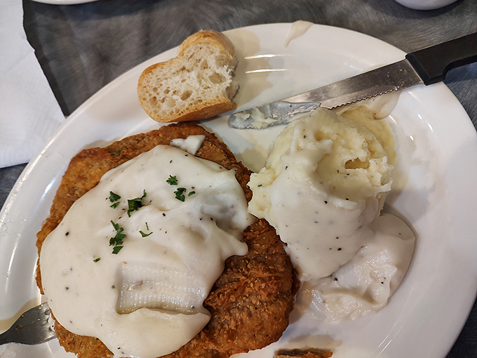 
Country fried steak smothered in creamy gravy alongside fluffy mashed potatoes&mdash;the kind of plate that makes you want to hug the cook afterward. 
