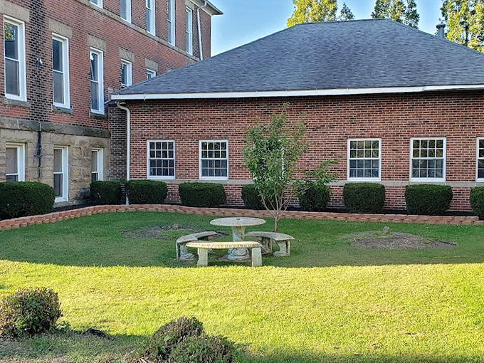 A peaceful courtyard offers a momentary reprieve from the building's intensity. The stone table&mdash;a place for reflection or perhaps ghostly gatherings?