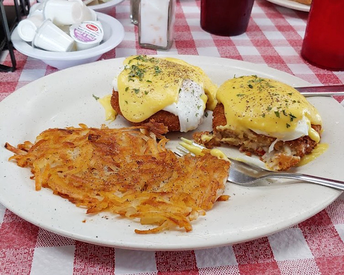 Eggs Benedict gets the coastal Florida treatment with crab cakes. Hollandaise sauce should always cascade like this &ndash; confident and unapologetic.