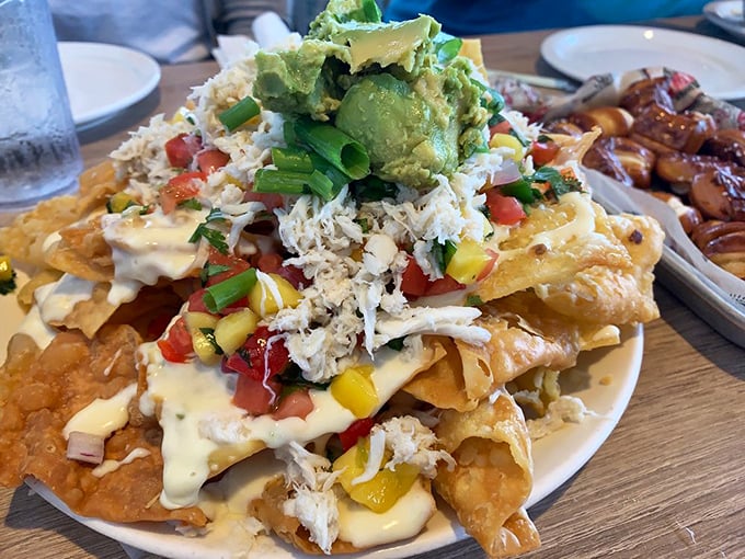 Seafood nachos that defy gravity and expectations. Crab meat, avocado, and cheese create a tower of flavor that demands to be shared.