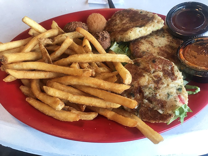 Golden-brown crab cakes that don't hide behind fillers&mdash;just pure crabby goodness with a side of crispy fries that demand attention.