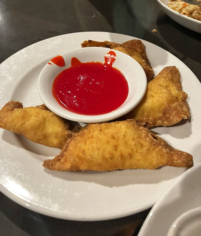 Golden-fried crabmeat rangoon with that perfect crunch giving way to creamy filling&mdash;proof that simple pleasures are often the most satisfying.