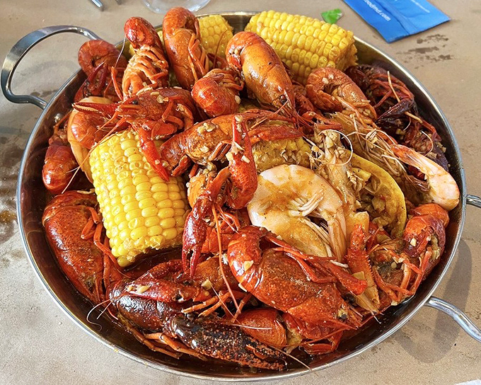 A crimson sea of crawfish and shrimp with corn lifeboats. This isn't just dinner&mdash;it's an expedition worth documenting.