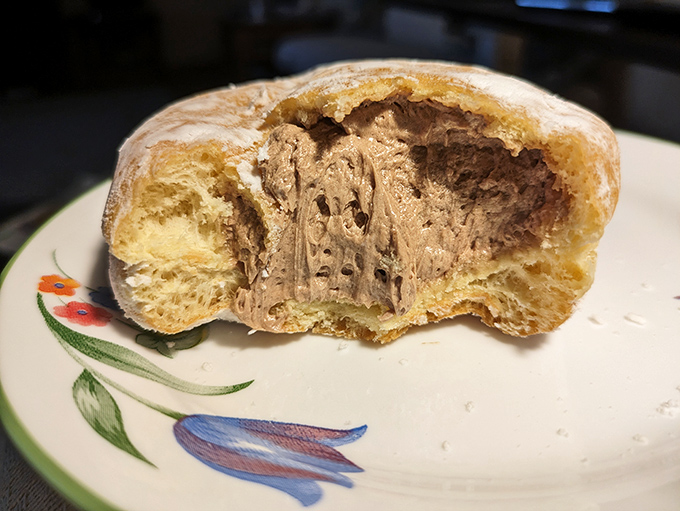 The cross-section reveals layers of cream that justify every single calorie about to be consumed.