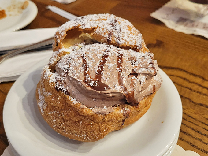 Not all heroes wear capes—some wear powdered sugar. This cream puff looks like it could single-handedly solve all of life's problems.