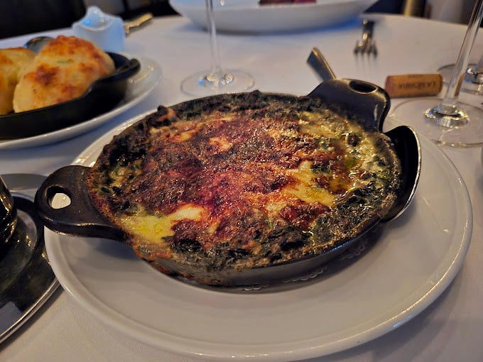 Creamed spinach that transforms Popeye's favorite vegetable into pure, bubbling comfort in a cast-iron skillet.