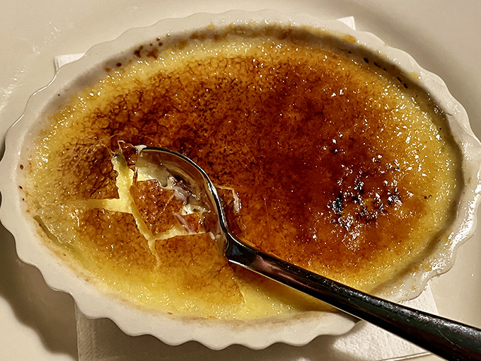 This crème brûlée isn't just dessert—it's performance art with that perfectly torched sugar top just begging for the satisfying crack of a spoon.
