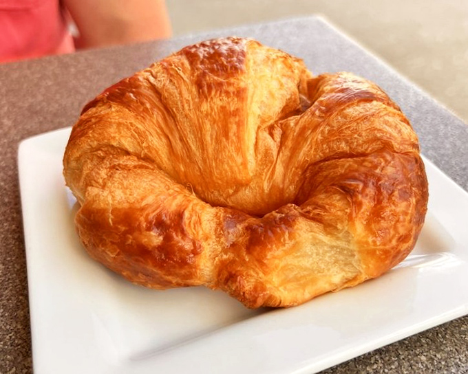 A croissant so perfectly golden and flaky, it practically whispers "good morning" in multiple languages. Butter's greatest achievement in pastry form.