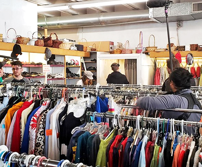 Treasure hunters in their natural habitat, scanning the racks with the focus of archaeologists on the brink of discovery.