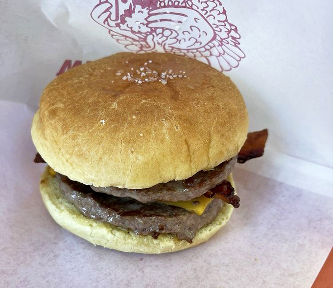 This double bacon cheeseburger isn't just defying gravity—it's defying the notion that simple food can't be extraordinary. The kind of burger that demands both hands and your full attention.