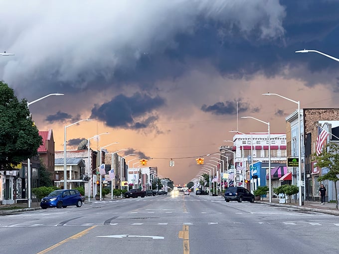 Storm clouds create dramatic theater above Ludington Street, painting the sky in moody purples and oranges that would make any photographer swoon.