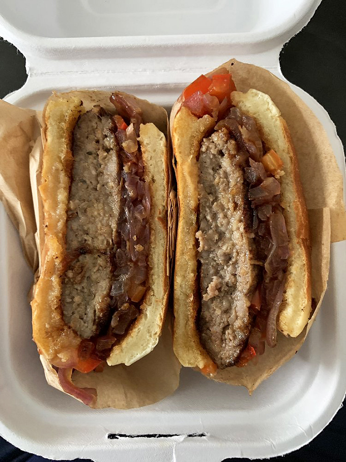 A sandwich so perfectly constructed it deserves its own architectural award&mdash;caramelized onions and sausage in harmonious balance like an edible symphony.