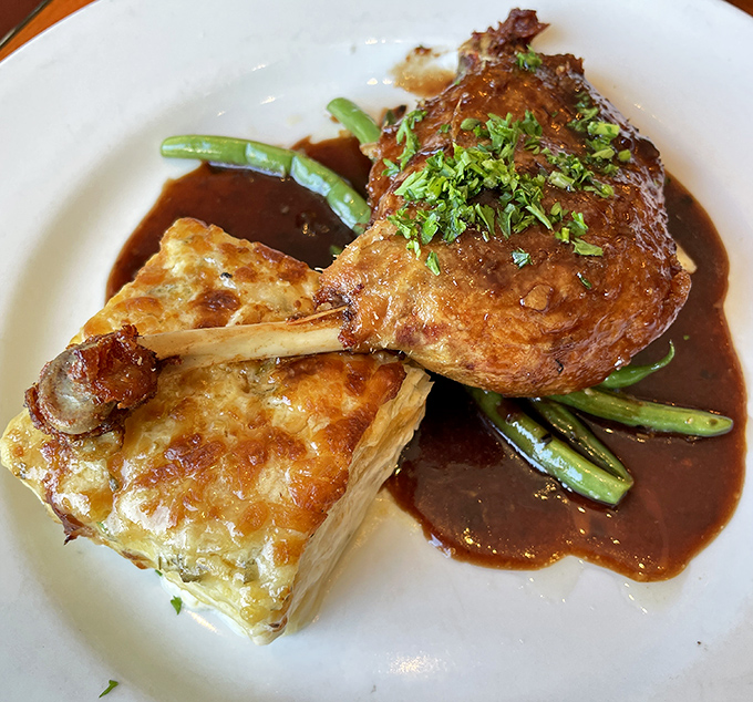 Duck confit that falls off the bone with just a stern look. Paired with that golden potato gratin, it's French comfort food at its finest.